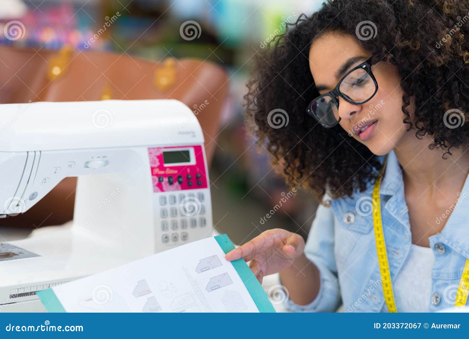 Female Dressmaker by Sewing Machine Studying Pattern Stock Image ...