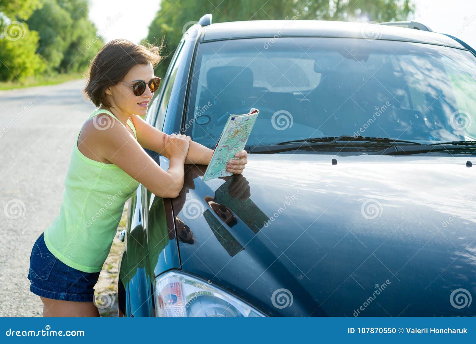 A Female Driver Reading a Map Near a Car Stock Photo - Image of lost ...