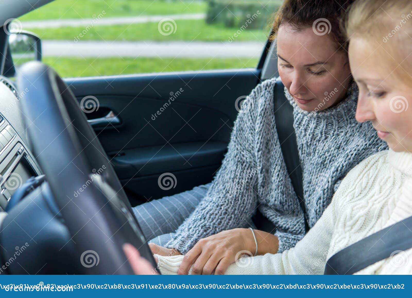 Female Driving Instructor Teaches a Female Student To Drive a Car Stock ...