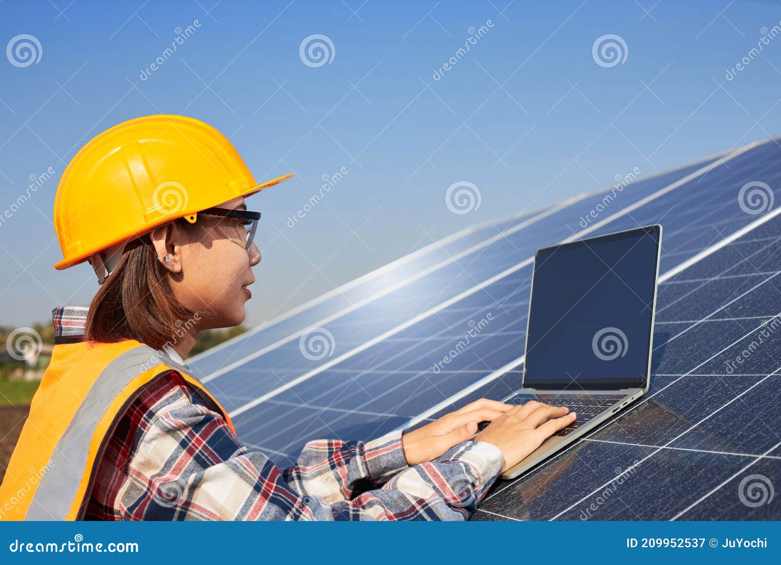 A Female Electrical Engineer is Using a Laptop To Control the Operation ...