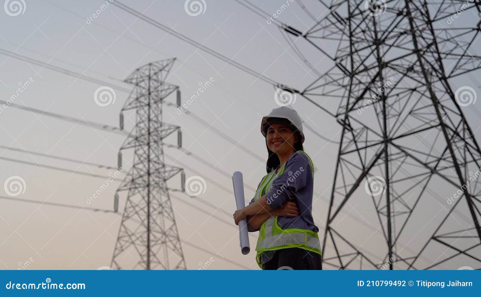 Female Electrical Engineer Working Near To High Voltage Tower. Stock ...