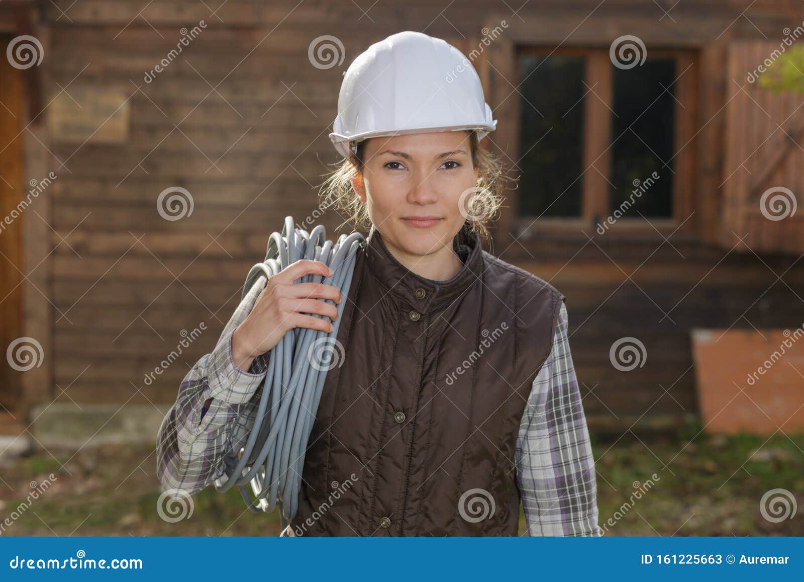 Female Electrician Carrying Cables Stock Image - Image of outside ...
