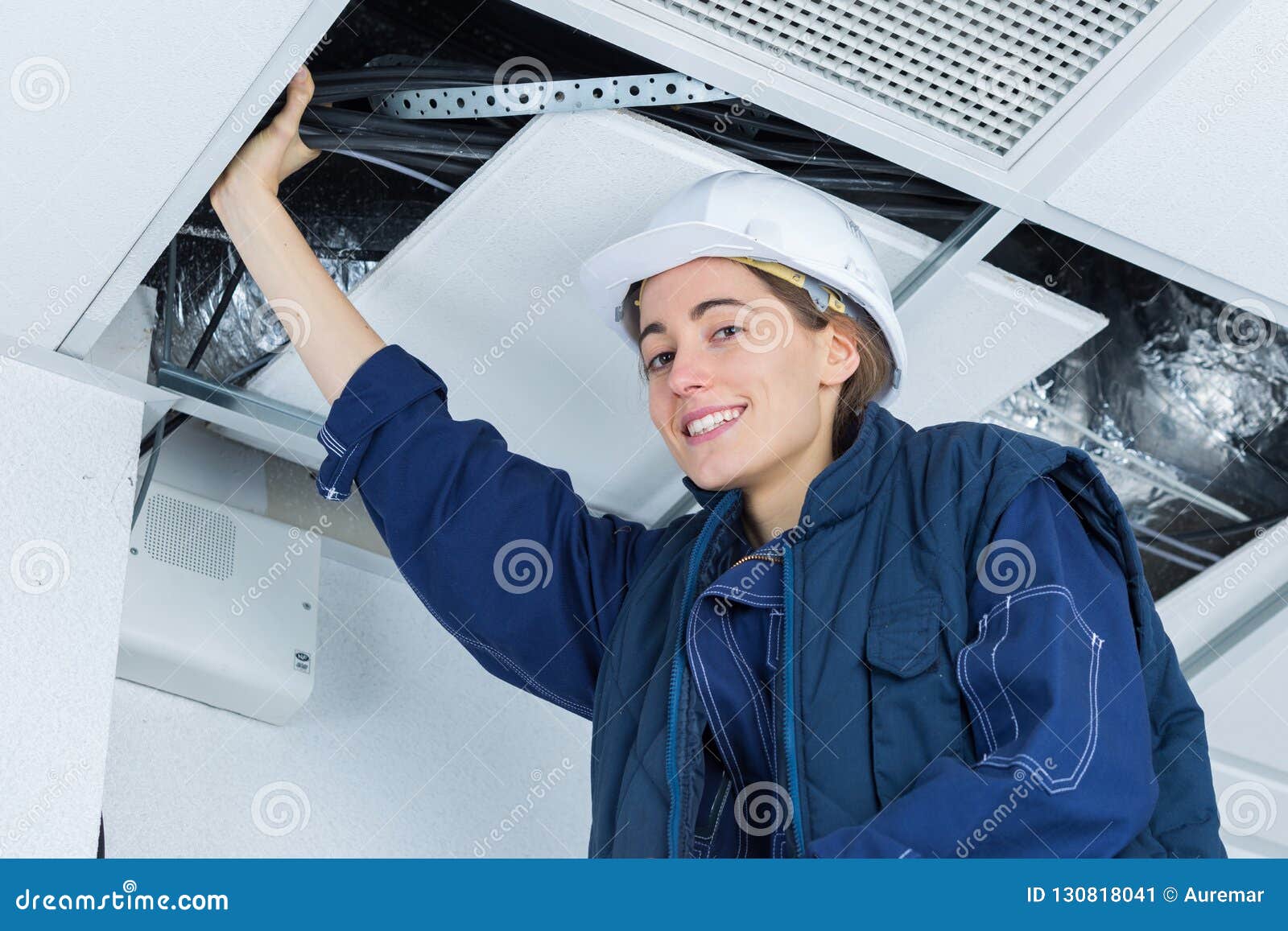 Female Electrician Installing Electric Device in Ceiling Stock Image ...