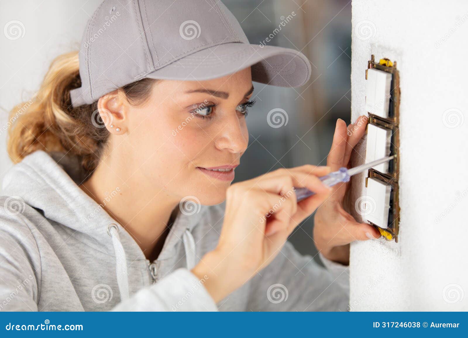 Female Electrician Installing Light Switches Stock Photo - Image of ...