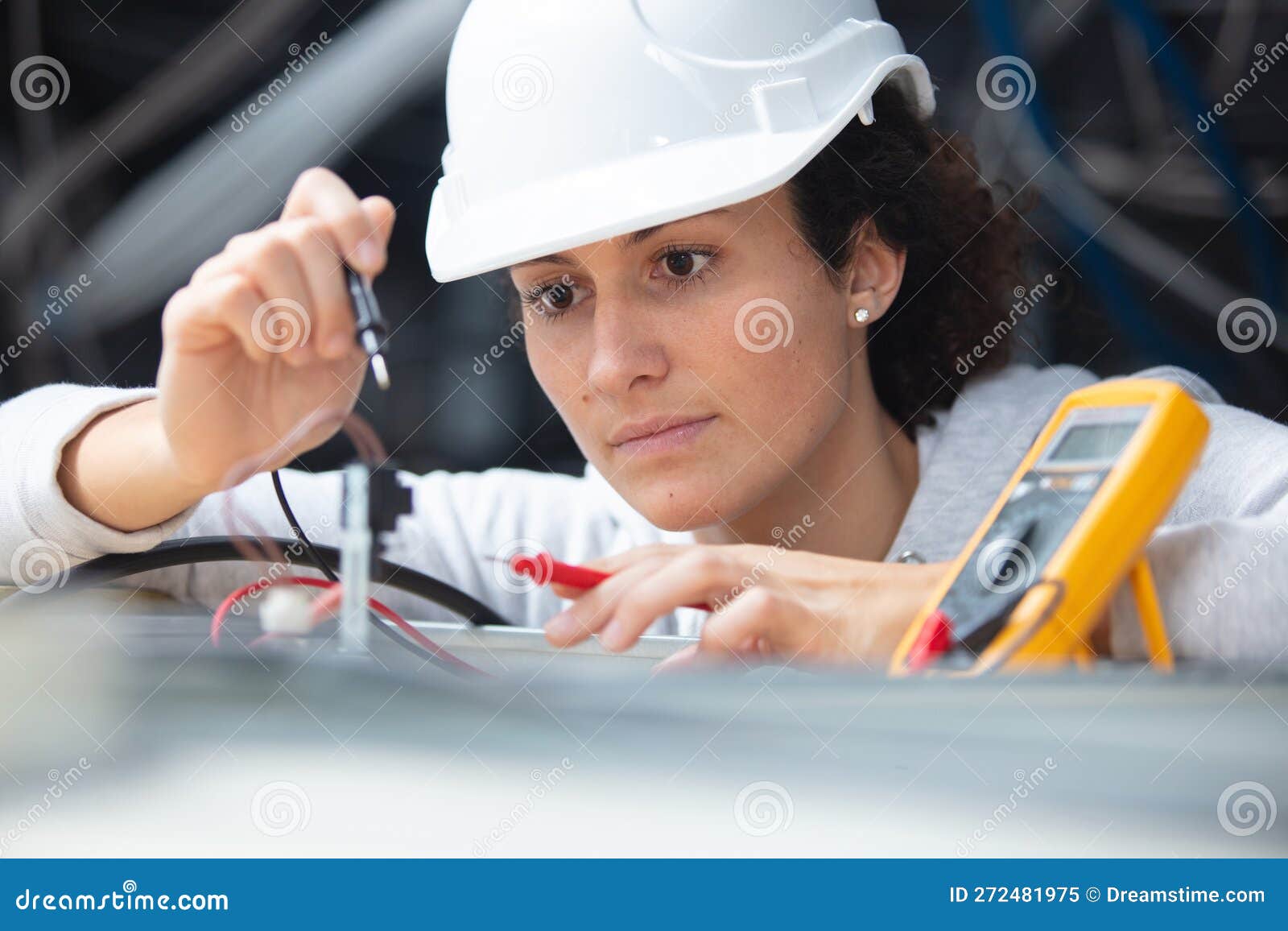 Female Electrician Testing Charge To Spotlight Stock Image - Image of ...