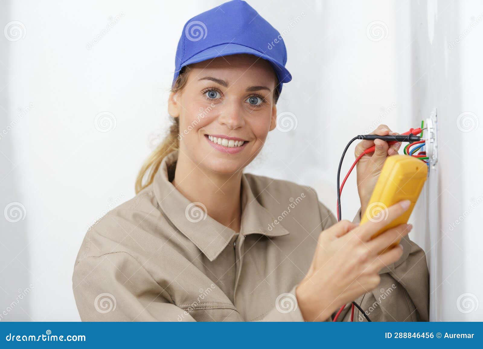 Female Electrician Testing Wall Socket Stock Photo - Image of female ...