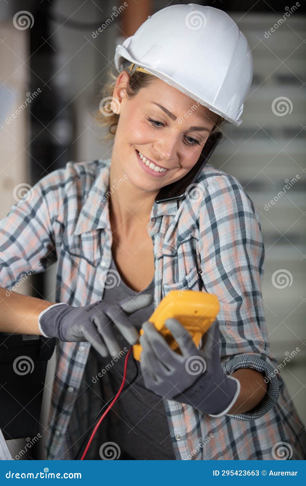 Female Electrician Using Multimeter while Talking on Telephone Stock ...