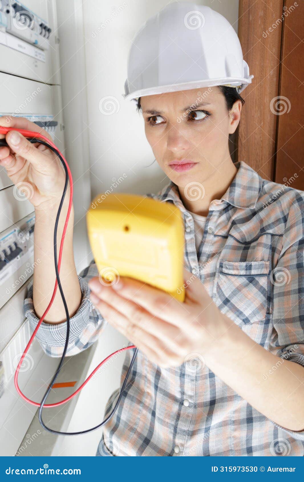 Female Electrician Using Multimeter To Test Electrical Cabinet Stock ...