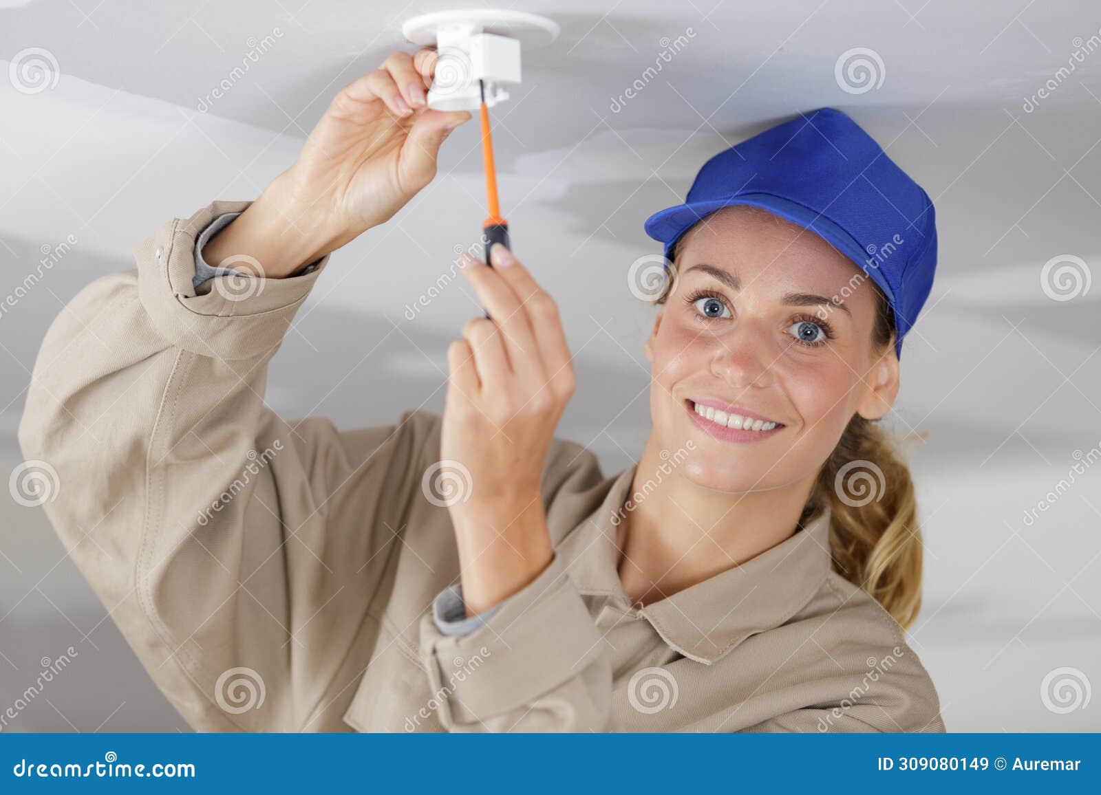 Female Electrician Working on Light Fitting Stock Image - Image of ...