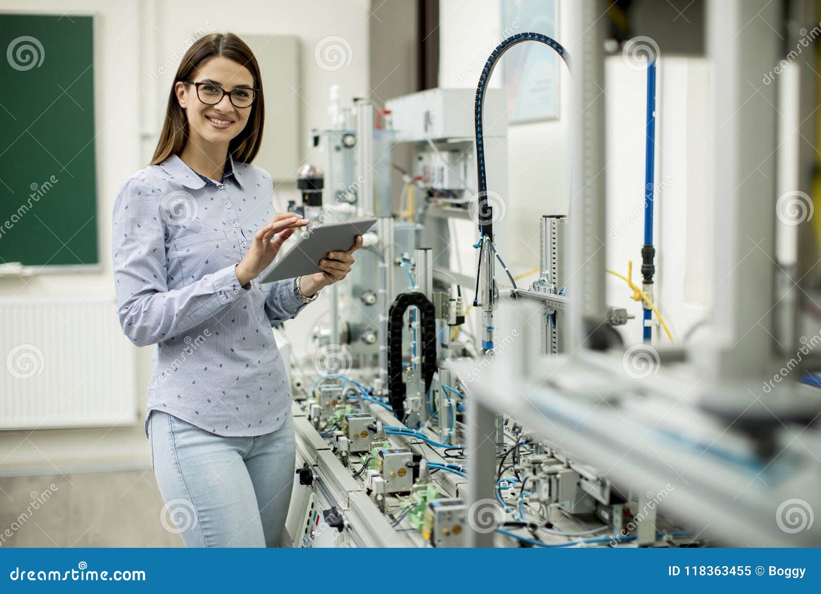 Female Electronic Engineer Checking Electronic Circuit In Laboratory ...