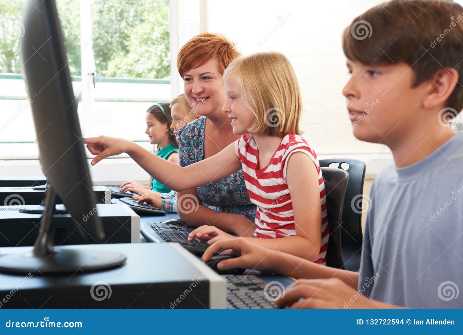 Female Elementary Pupil in Computer Class with Teacher Stock Photo ...