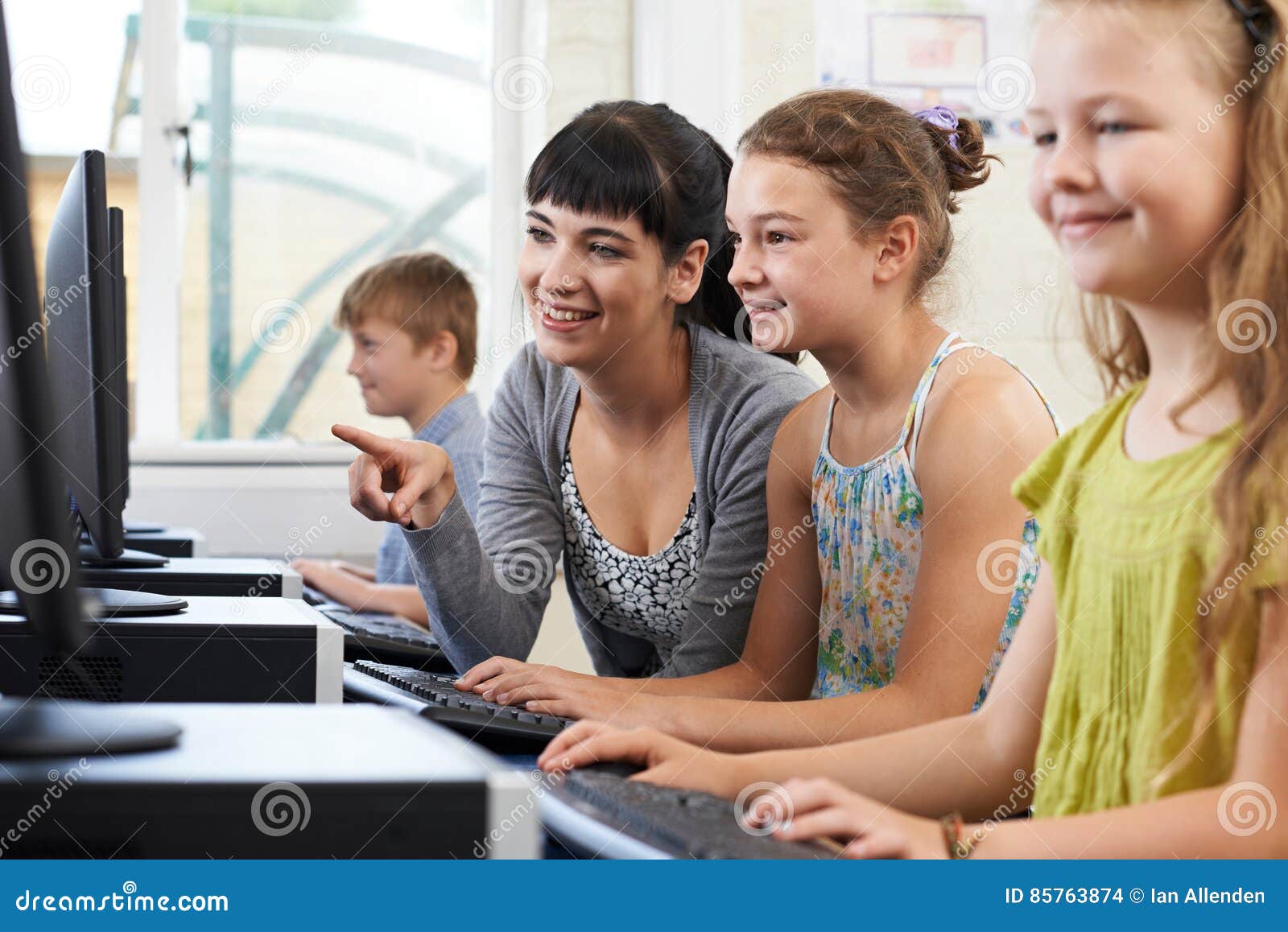 Female Elementary Pupil in Computer Class with Teacher Stock Photo ...