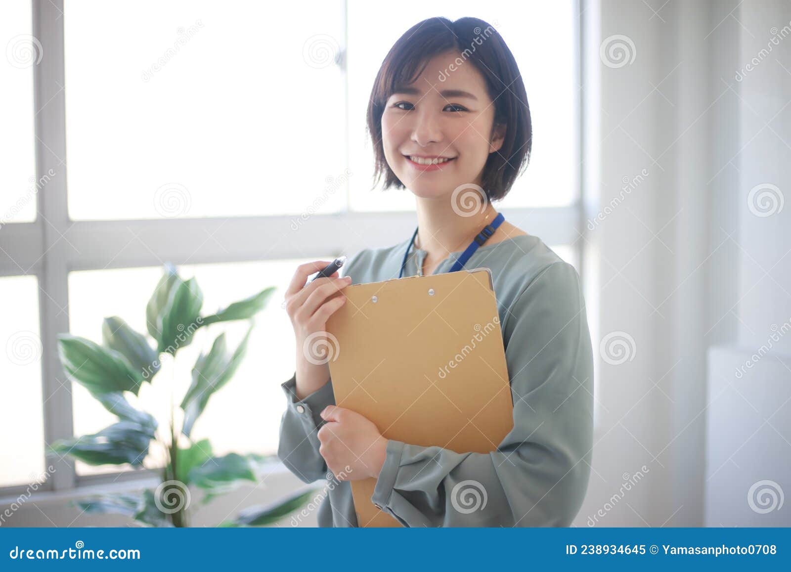 Female Employee with a Binder Stock Image - Image of facial, adult ...