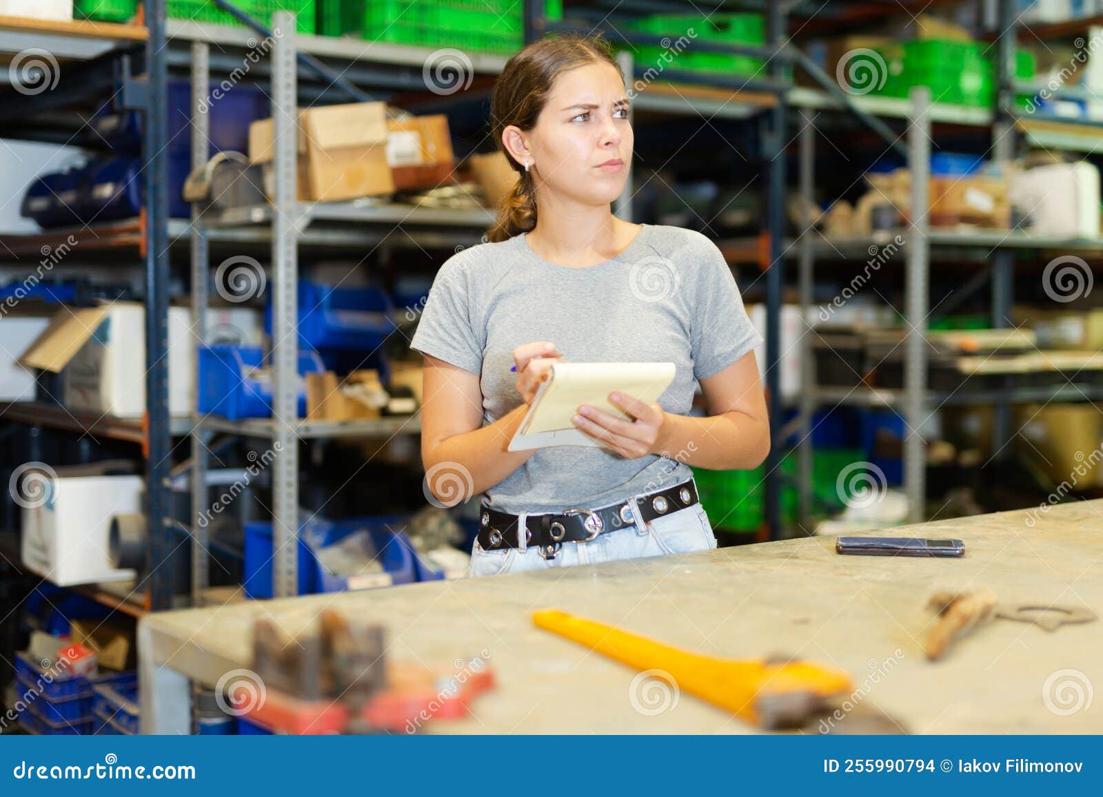 Female Employee of Hardware Store Makes Notes in a Notebook Stock Photo ...