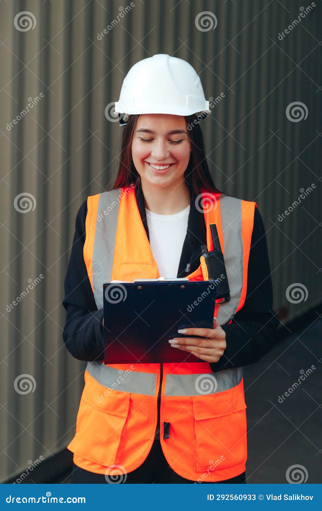 Female Engineer with Clip Folder in White Helmet and Vest Working in ...