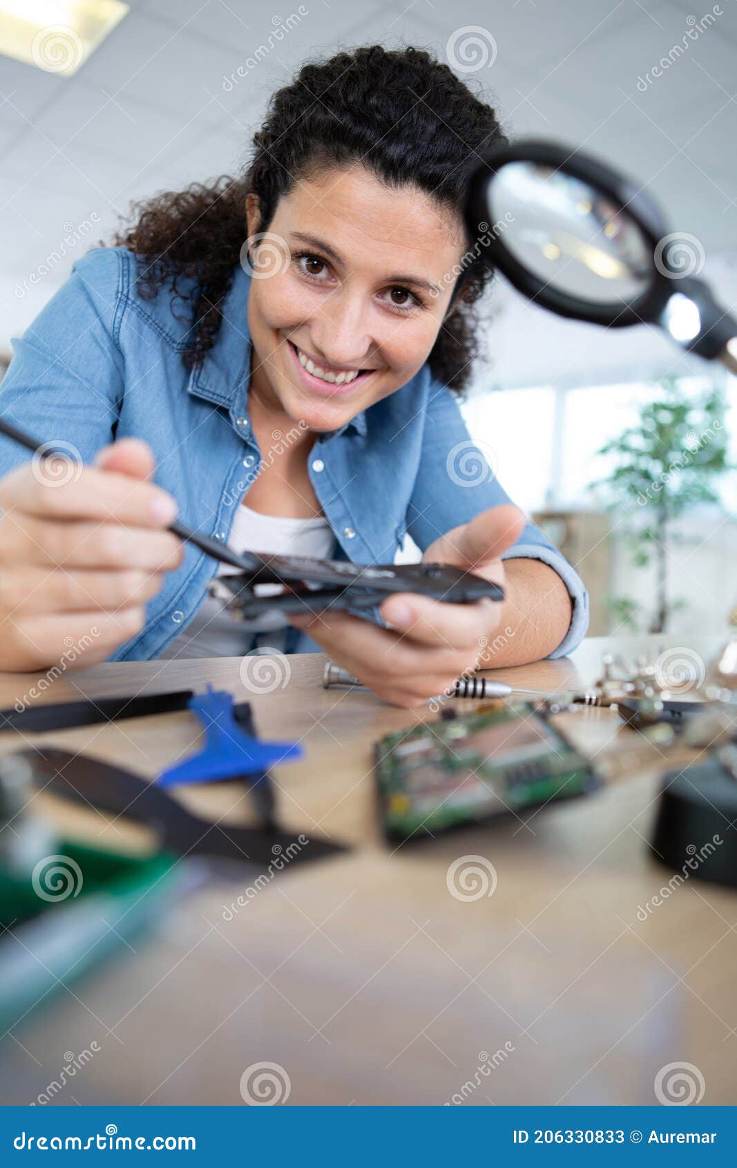 Female Engineer Looking at Circuit through Magnifying Glass Stock Image ...