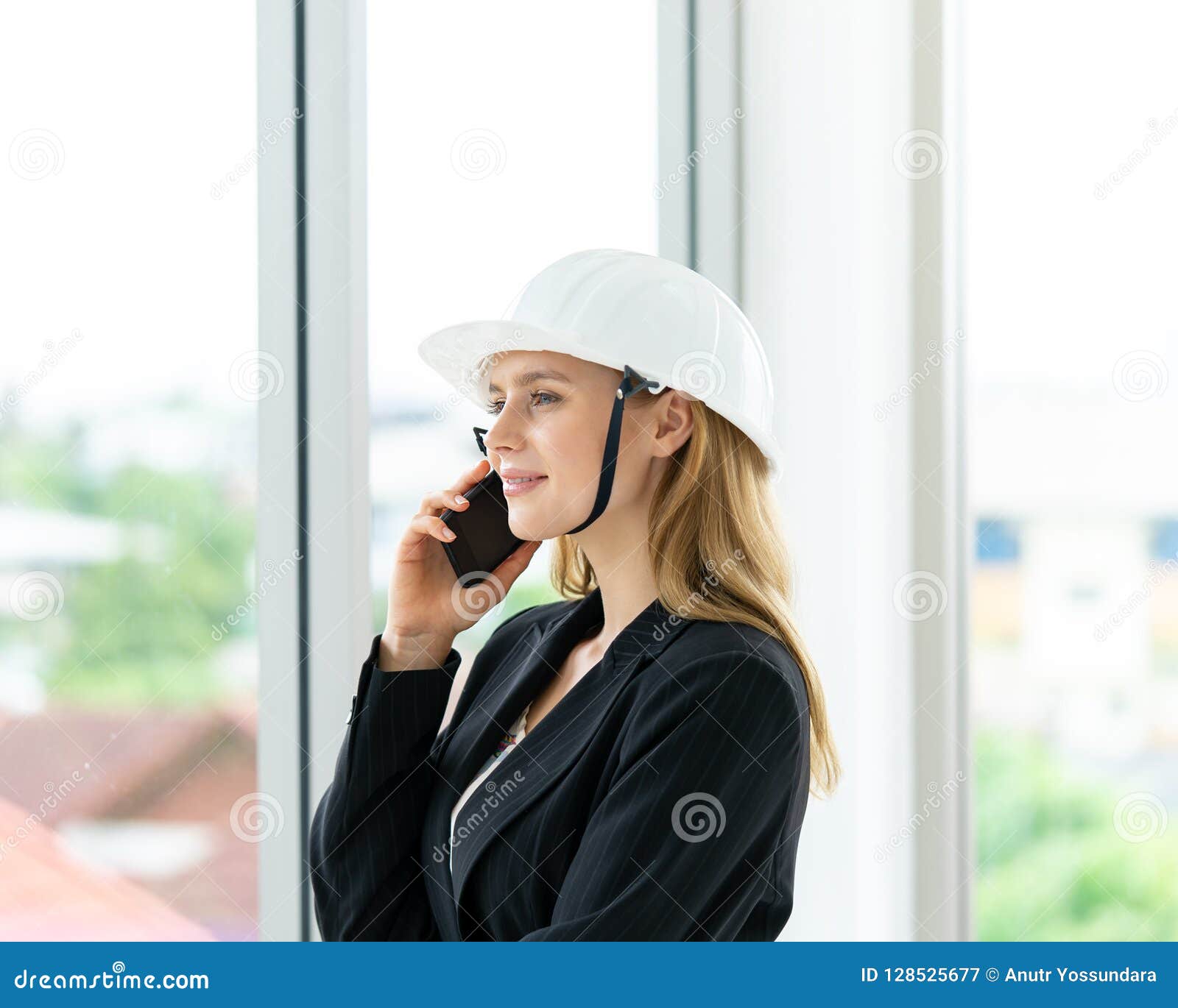 Female Engineer Making Call in Office Building Stock Image - Image of ...