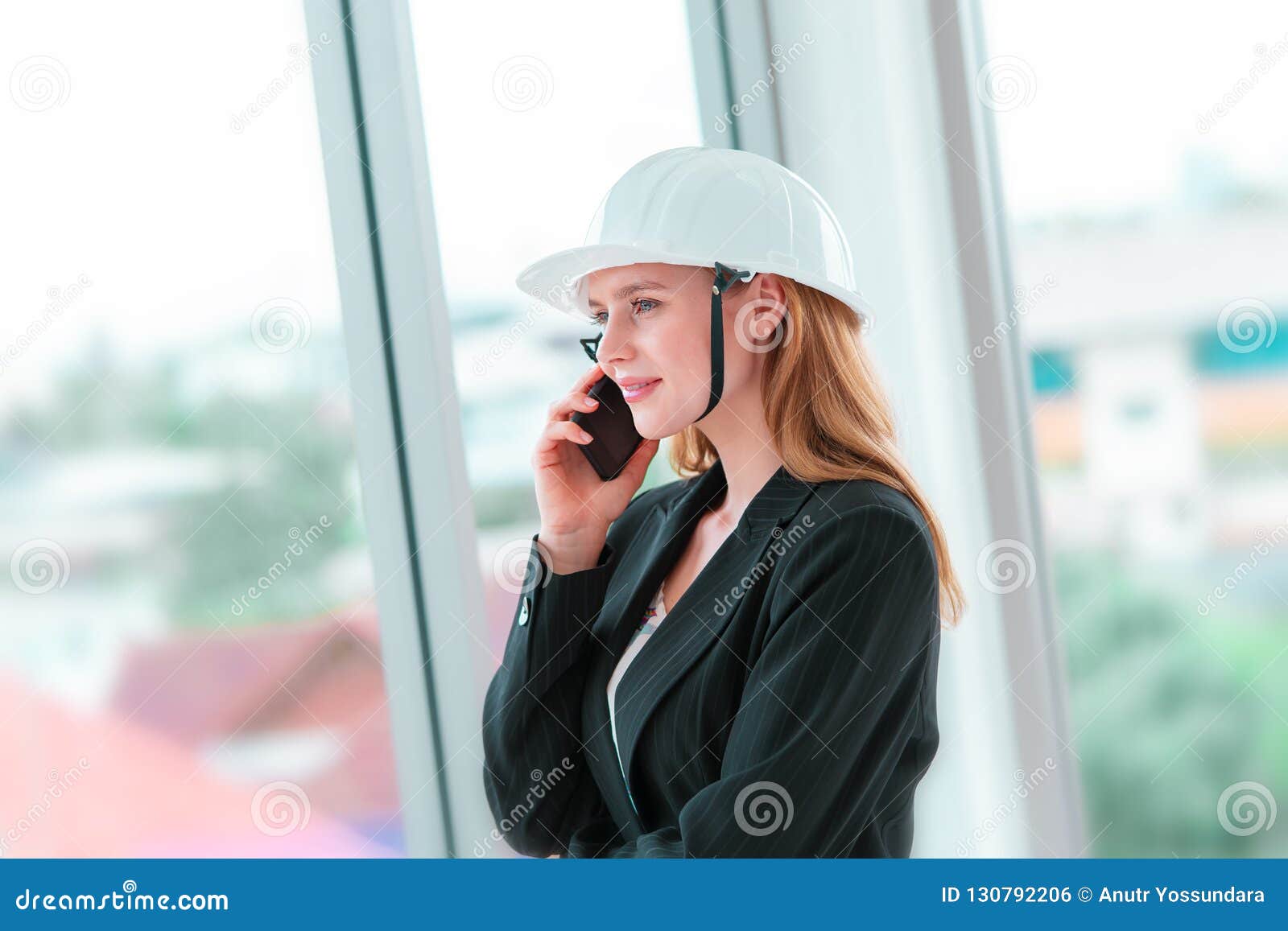 Female Engineer Making Call in Office Building Stock Photo - Image of ...