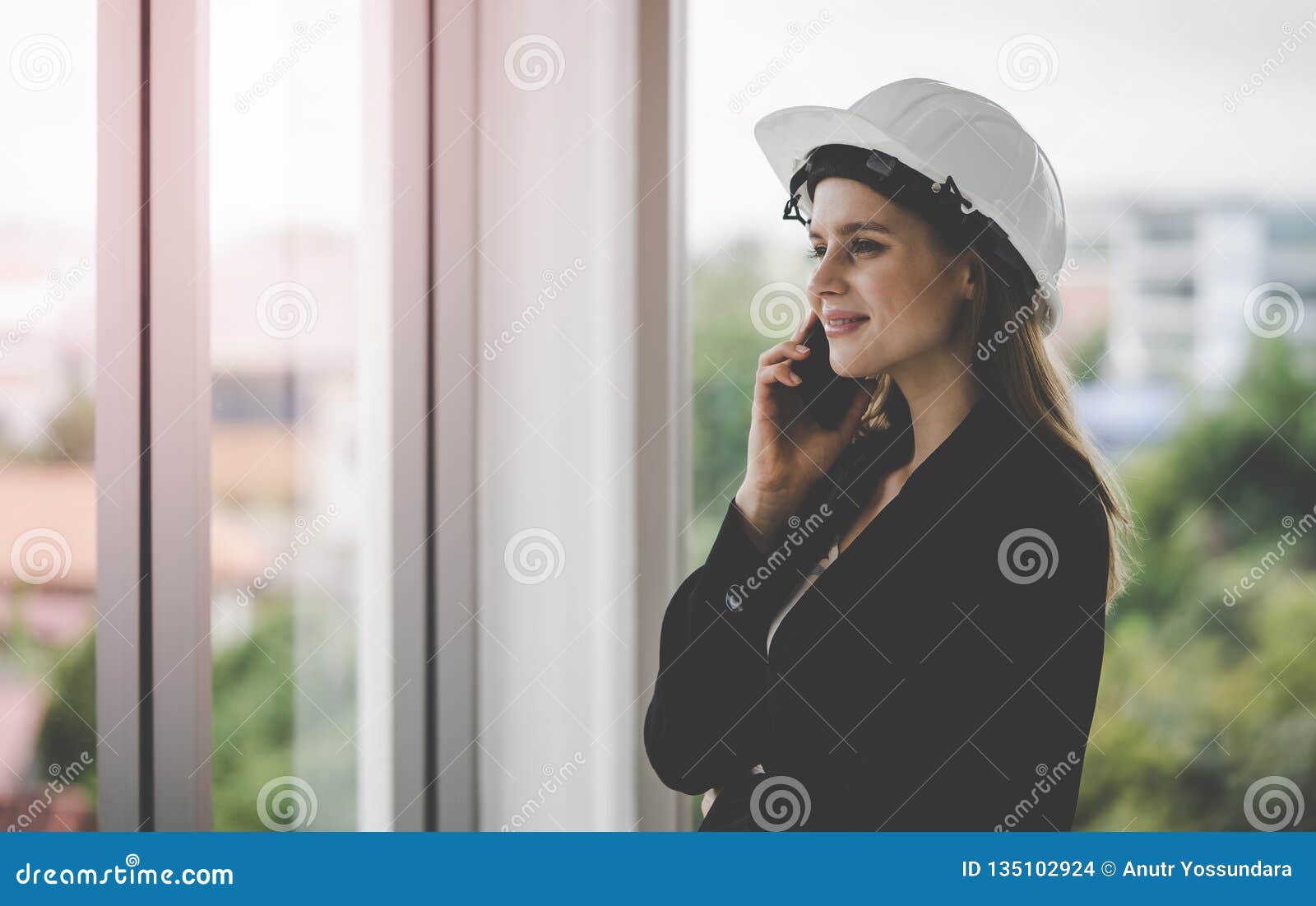 Female Engineer Making Call in Office Building Stock Photo - Image of ...