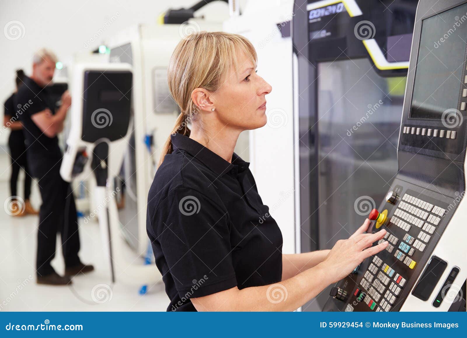 Female Engineer Operating CNC Machinery on Factory Floor Stock Photo ...