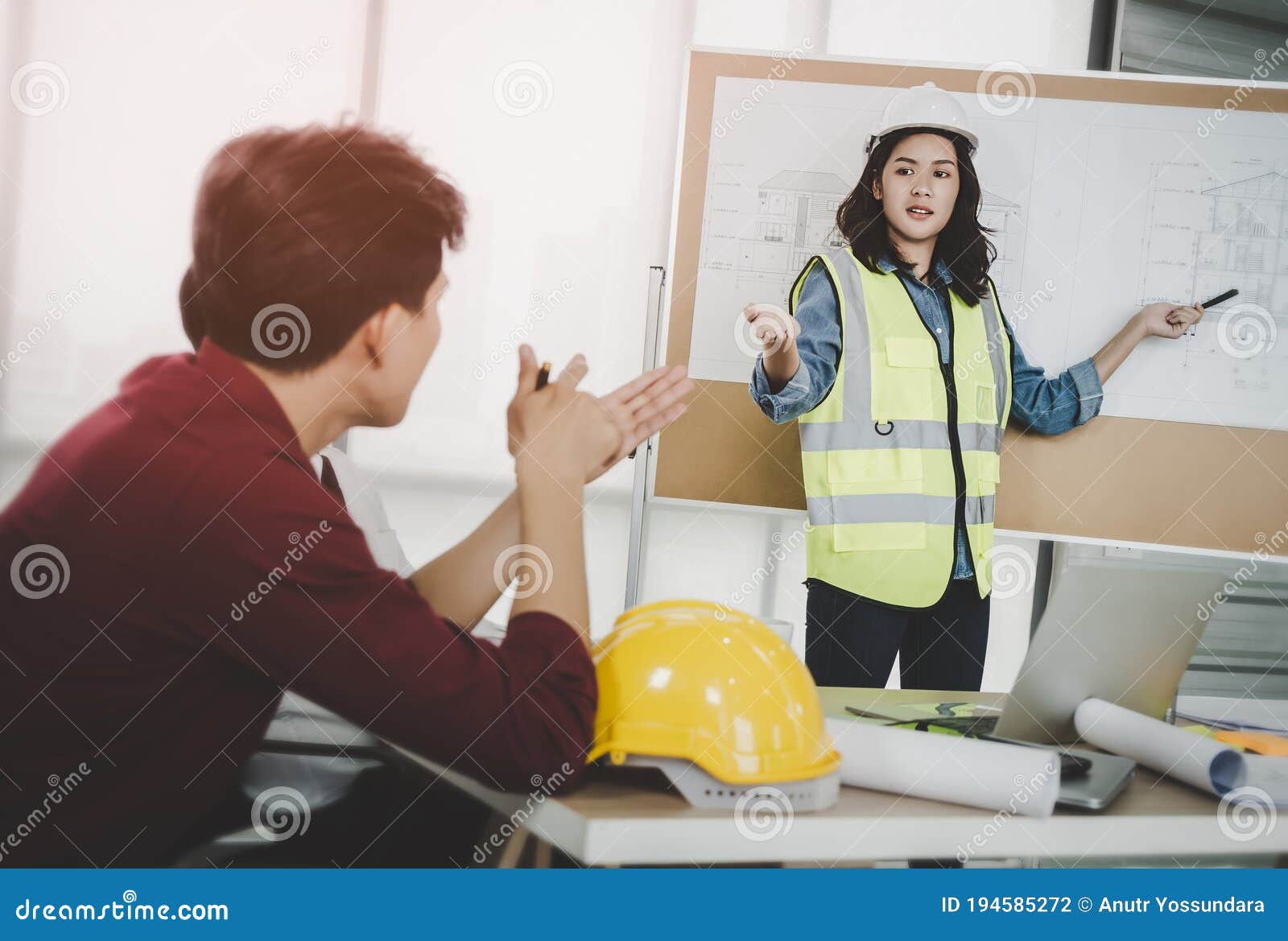 Female Engineer Presenting Her Architecture Drawing in Construction ...