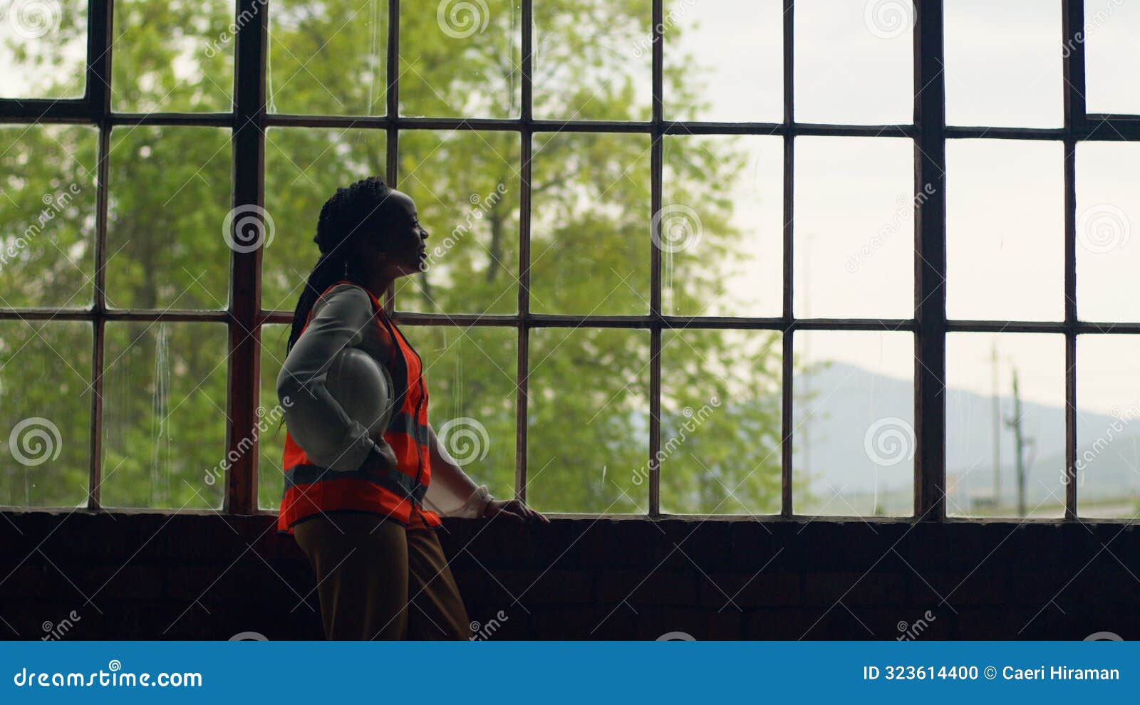 Female Engineer Reflecting by Window in Construction Setting with ...