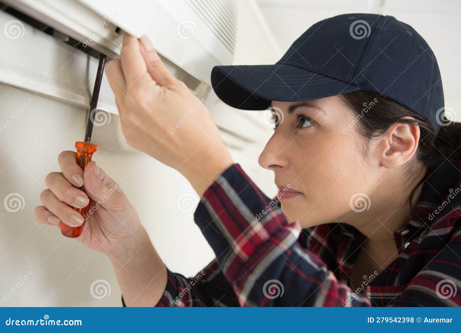 Female Engineer Repairing Wall Mounter Air Conditioning Unit Stock ...