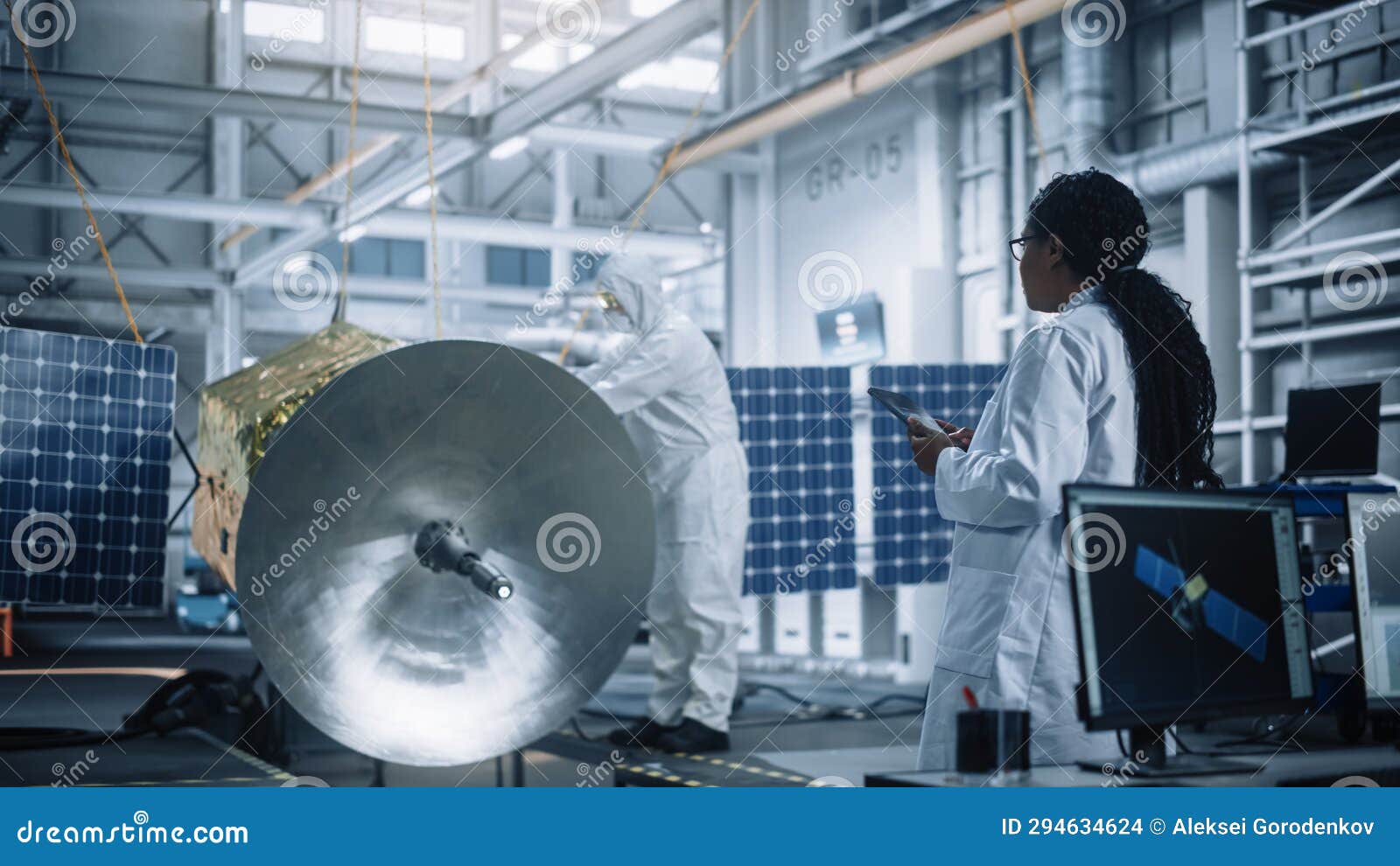Female Engineer Uses Tablet Computer while Working on Satellite ...