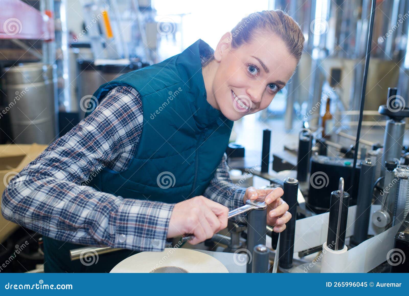 Female Engineer Using Spanner on Factory Conveyor Stock Image - Image ...