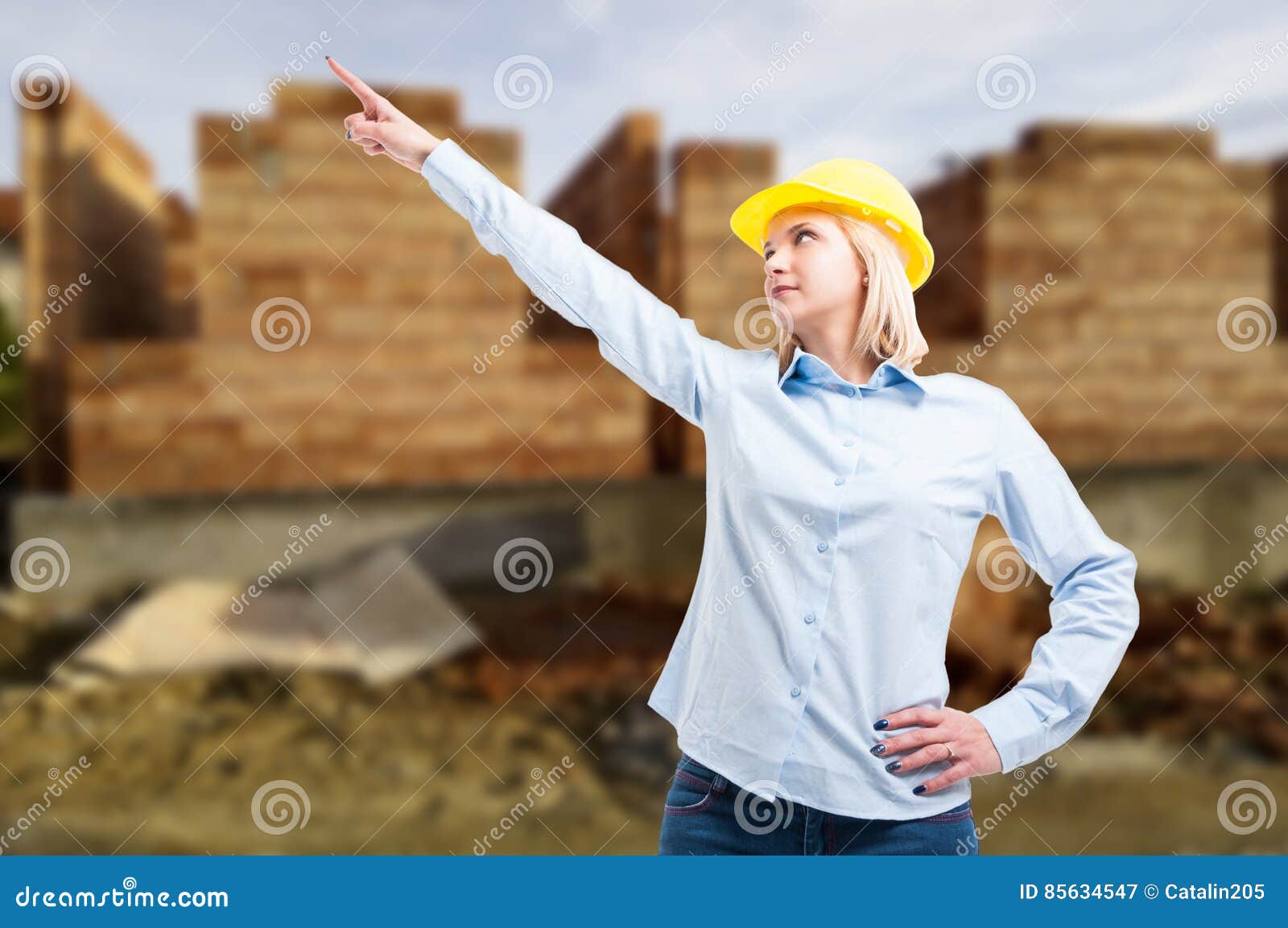 Female Engineer Wearing Helmet Pointing High on Development Stock Image ...