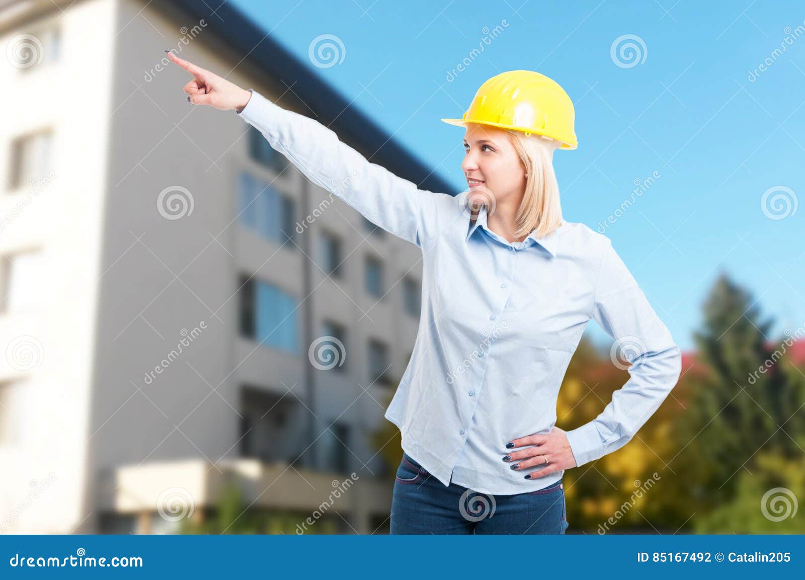 Female Engineer Wearing Yellow Helmet Pointing Something Stock Photo ...