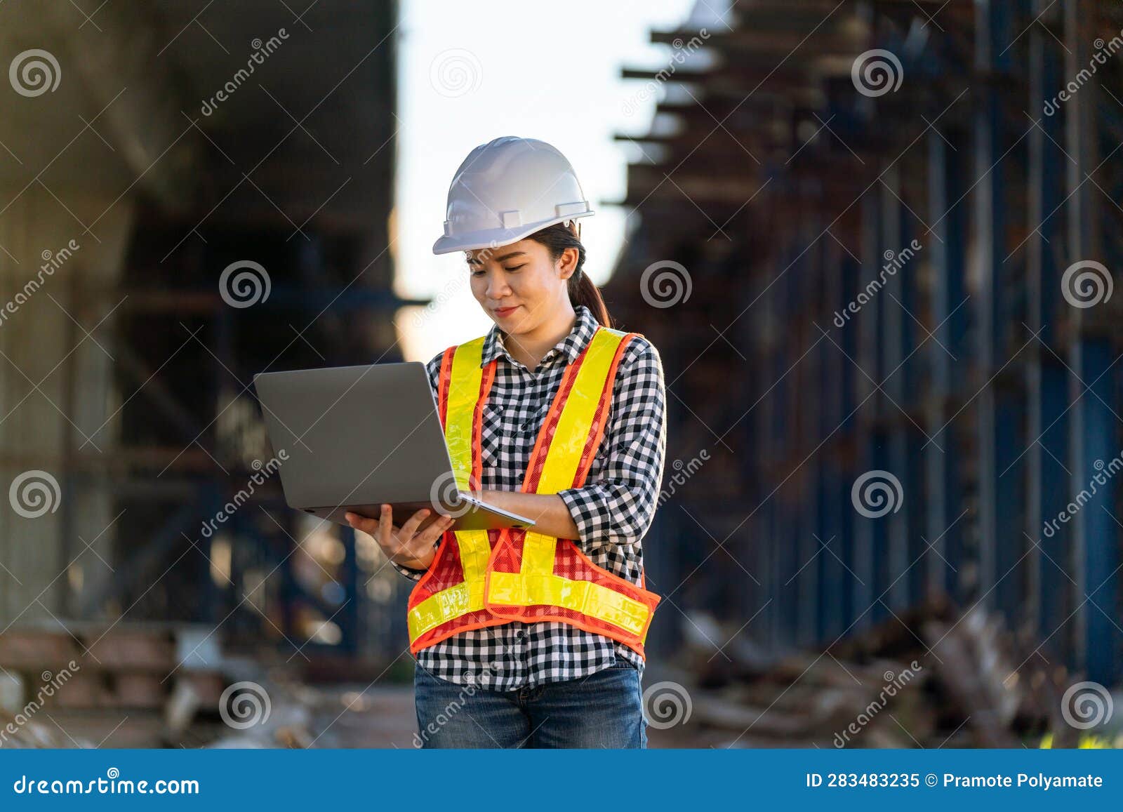 A Female Engineer Working on Laptop with New Technologies and ...