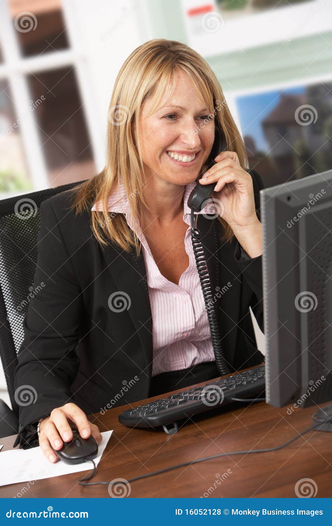 Female Estate Agent Talking on Phone at Desk Stock Photo - Image of ...