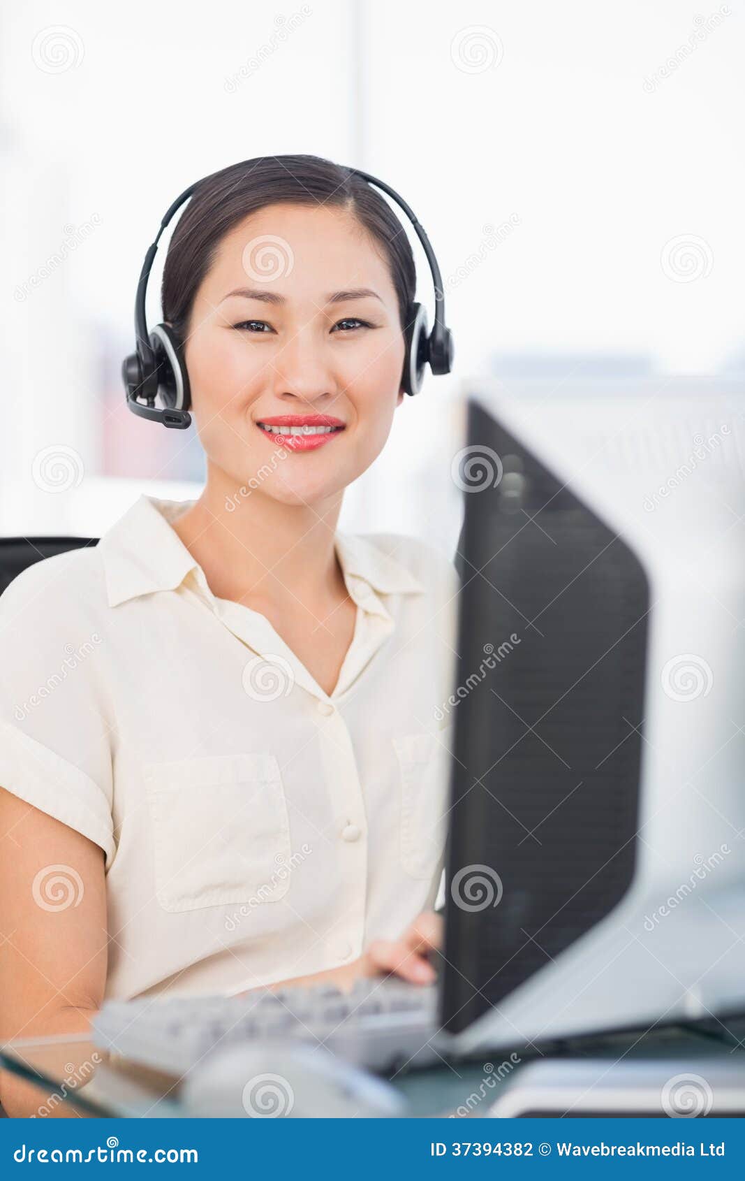 Female Executive with Headset Using Computer at Desk Stock Photo ...