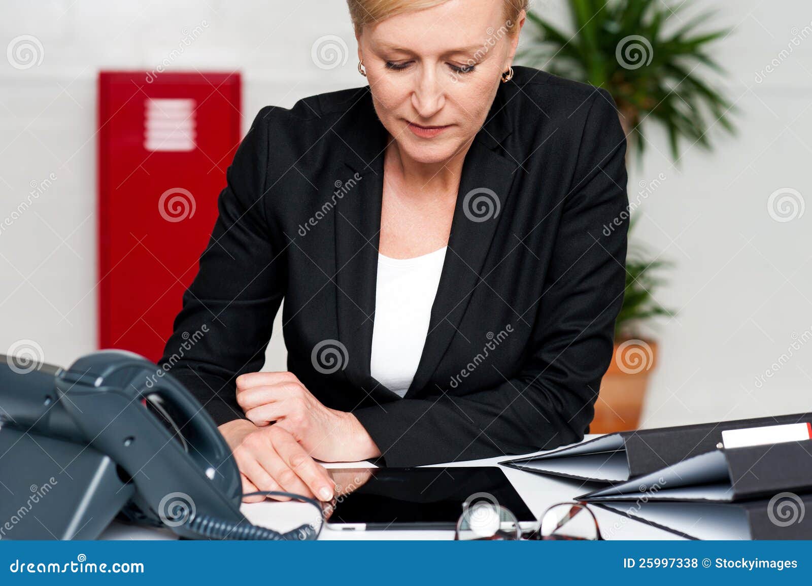 Female Executive Looking Down at Tablet Screen Stock Photo - Image of ...
