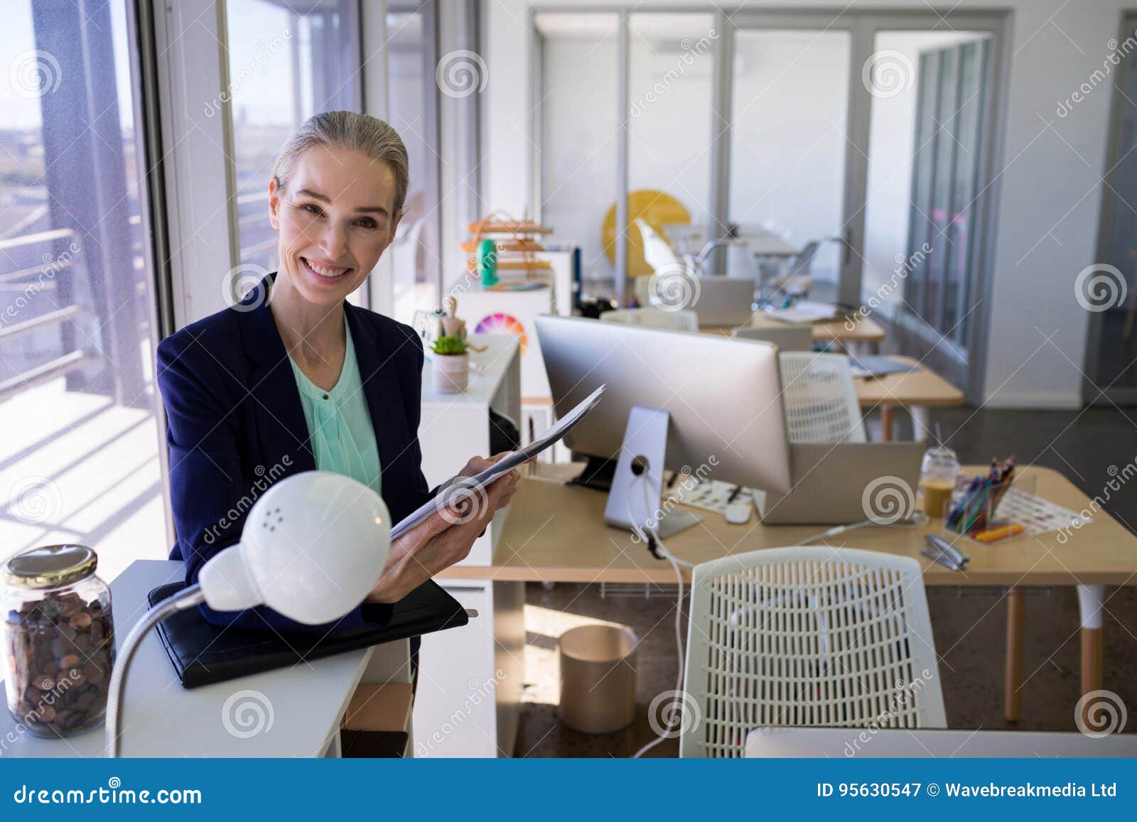 Female Executive Reading Document at Her Desk Stock Image - Image of ...