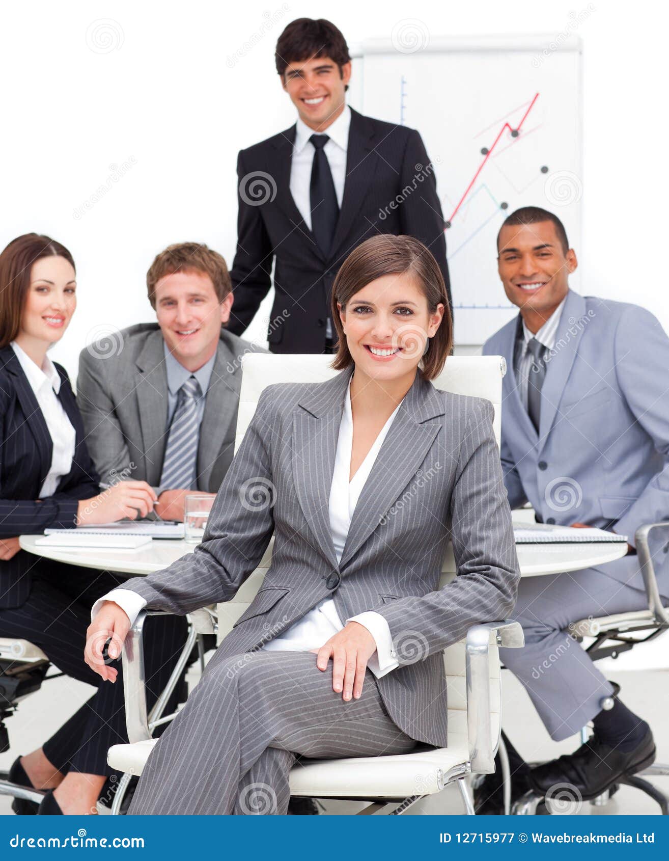 Female Executive Sitting in Front of Her Team Stock Image - Image of ...