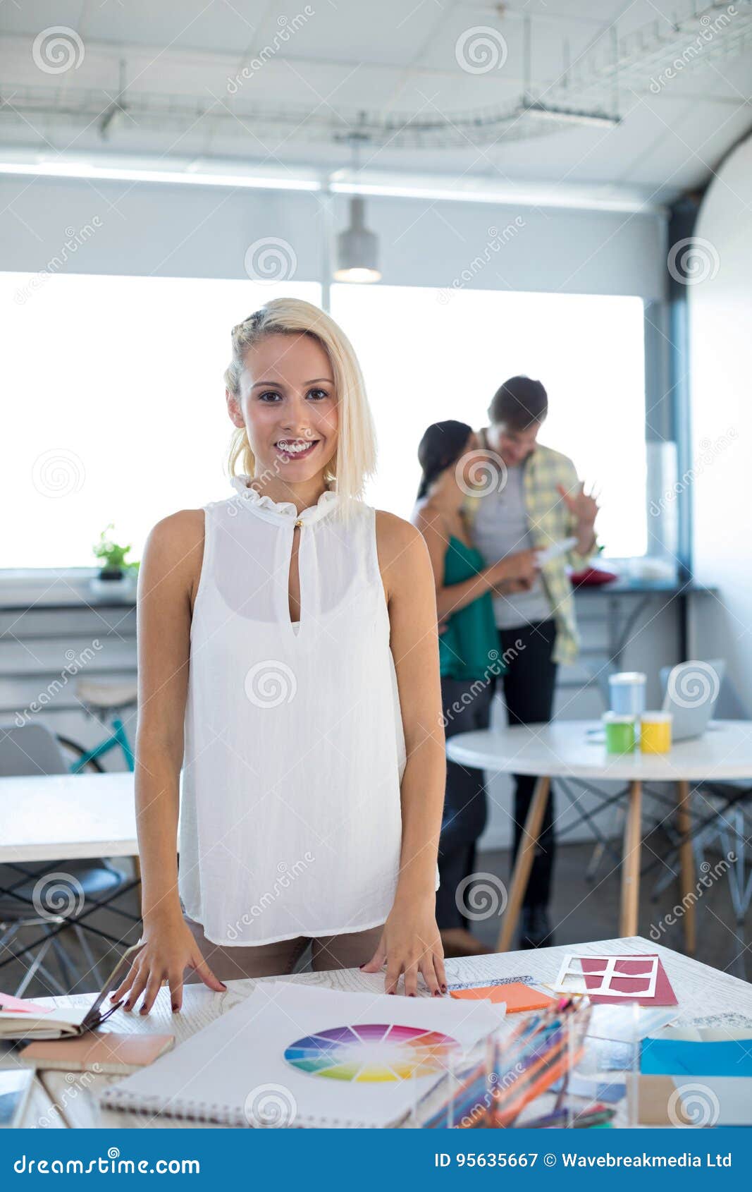 Female Executive Standing at Her Desk in Office Stock Image - Image of ...