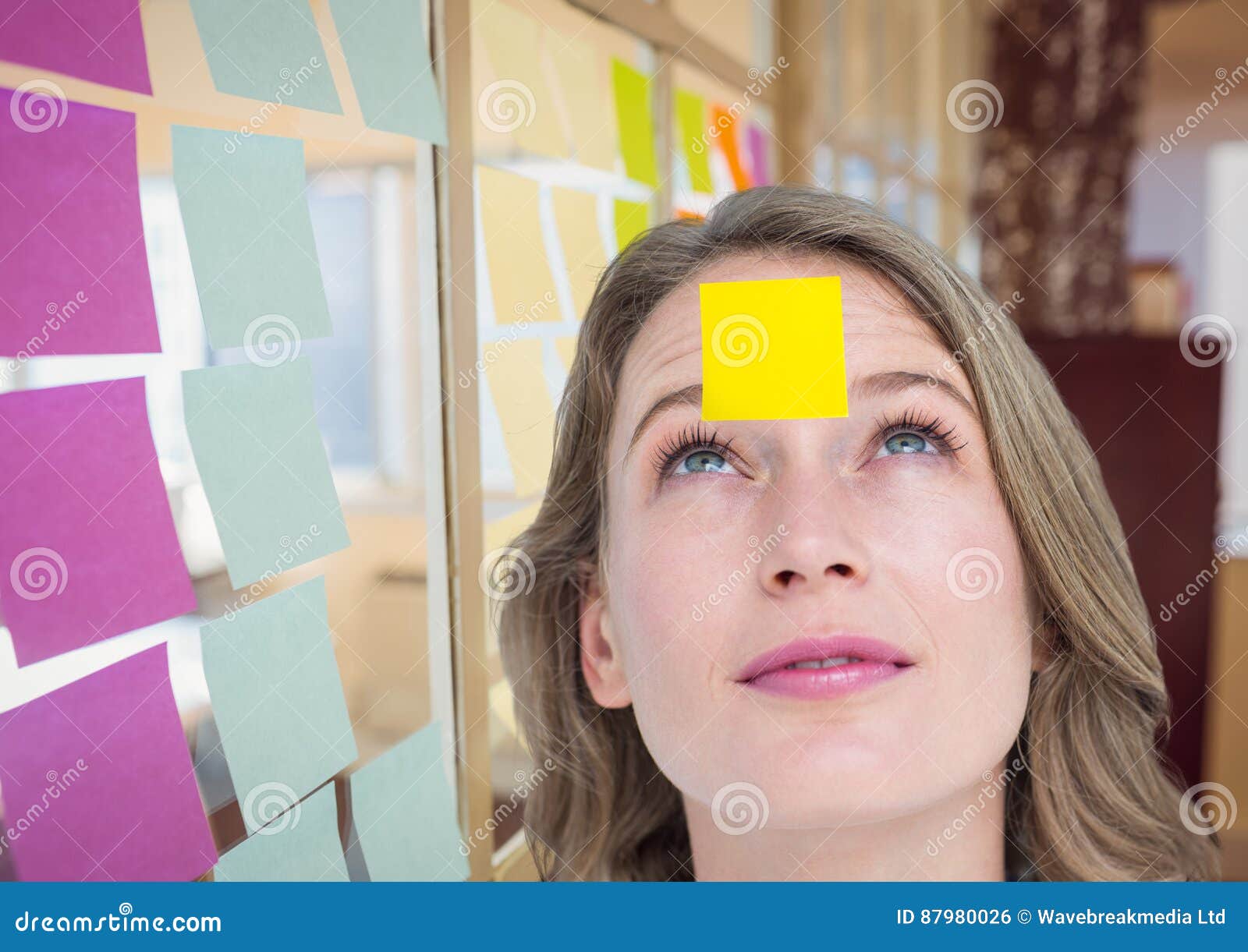 Female Executive with Sticky Note on Head in Office Stock Photo - Image ...