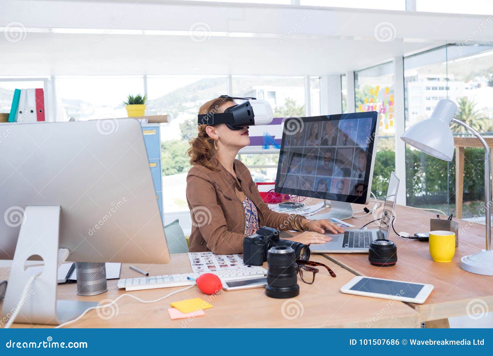 Female Executive Working on Laptop while Using Virtual Reality Headset ...