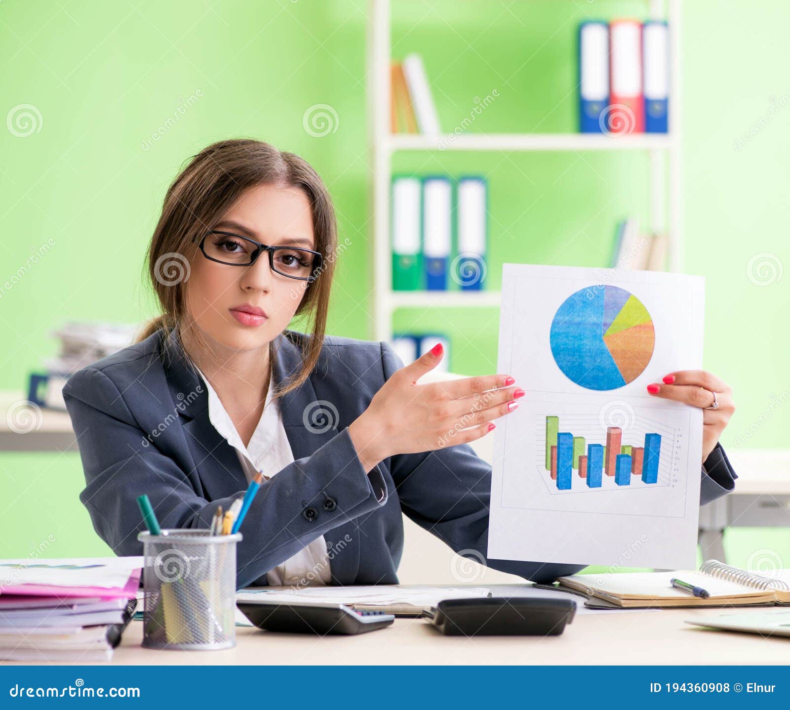 Female Financial Manager Presenting Graph Chart Sitting in the O Stock ...