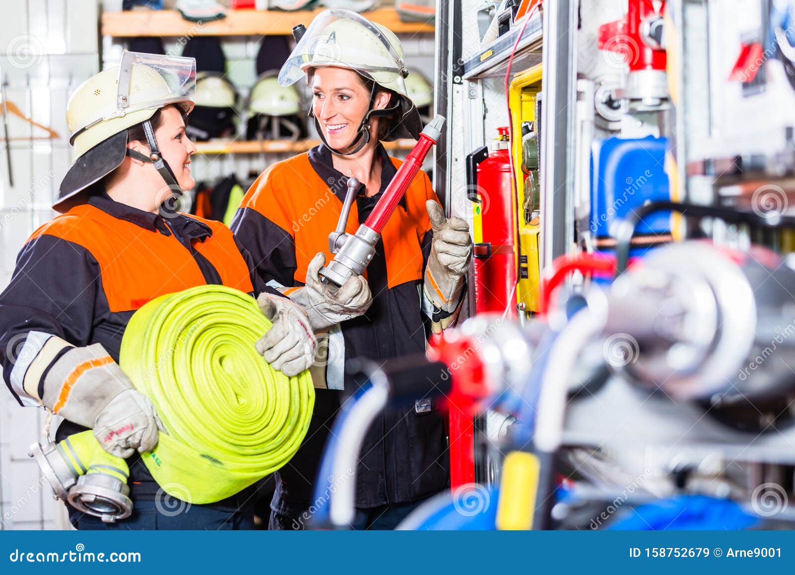 Fire Fighters Loading Hoses into Operations Vehicle Stock Image - Image ...