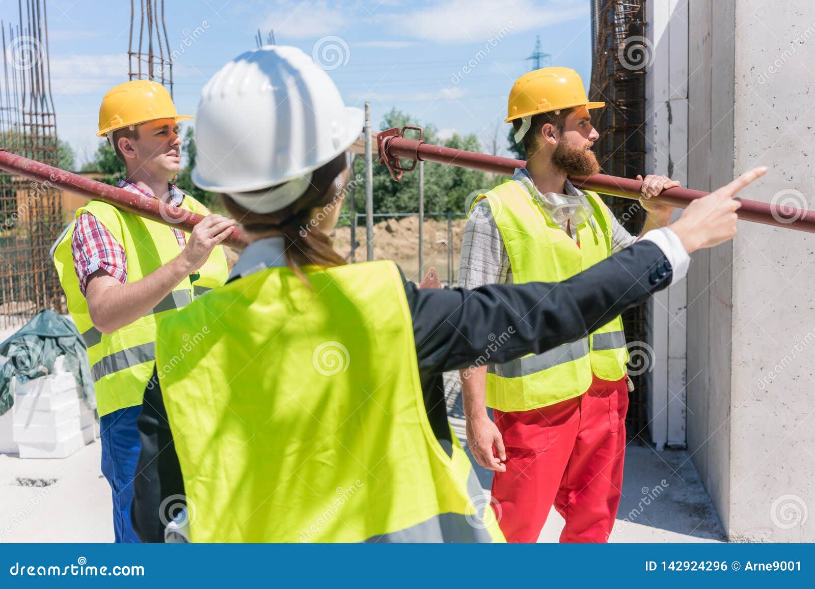 Female Foreman Coordinating and Guiding Workers on the Construction ...