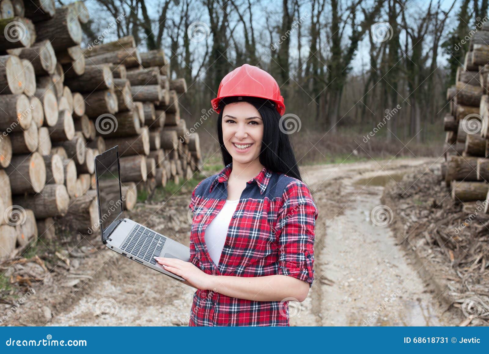 Female Forest Engineer beside Logs Stock Image - Image of helmet ...