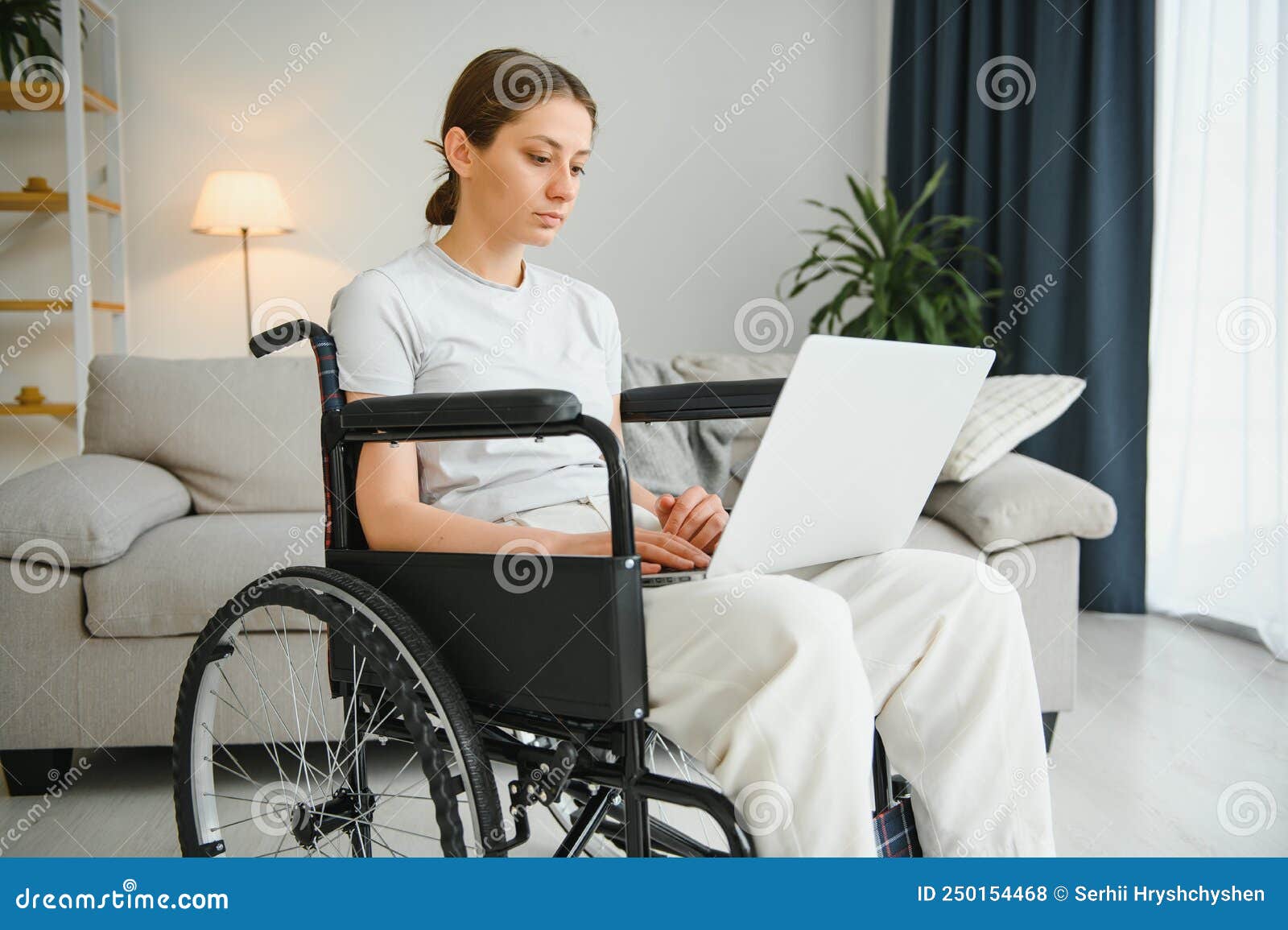 Female Freelance Programmer Sitting In Wheelchair And Using Computers While Coding Web Game At
