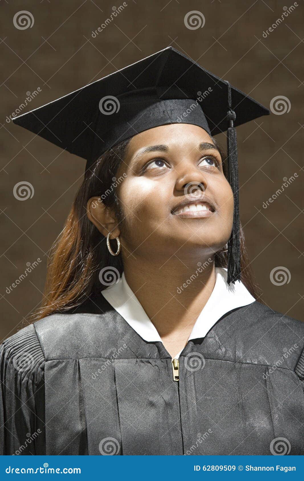 Female graduate looking up stock image. Image of accomplishment - 62809509