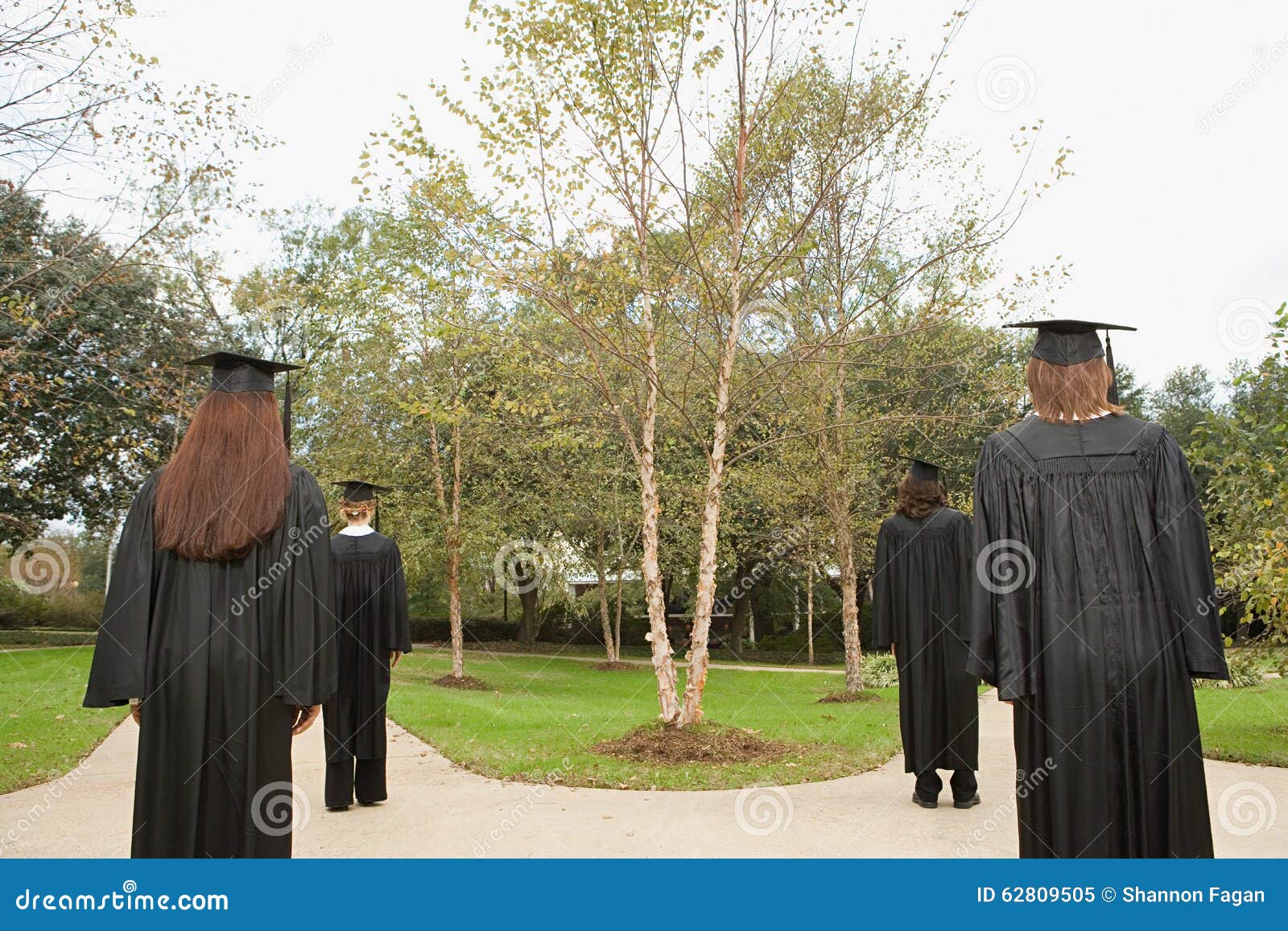 Female Graduates Walking Down Paths Stock Image - Image of forward ...