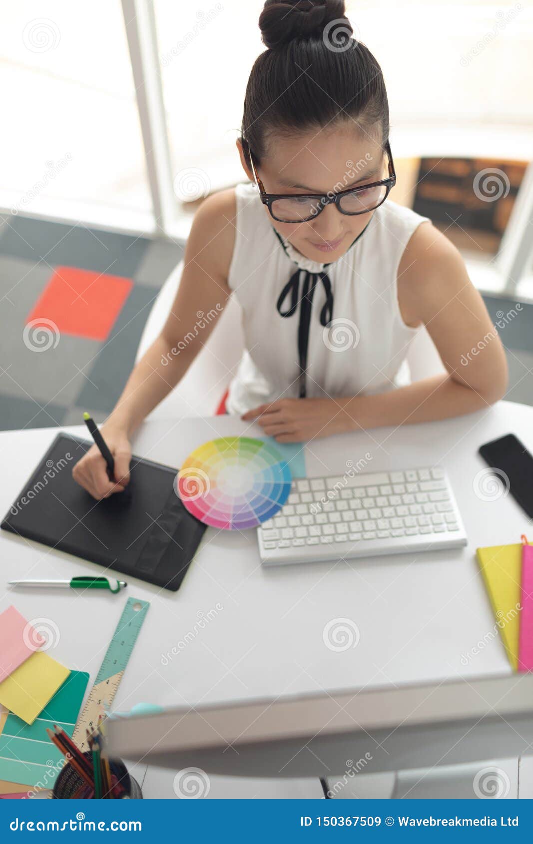 Female Graphic Designer Using Graphic Tablet at Desk in a Modern Office ...