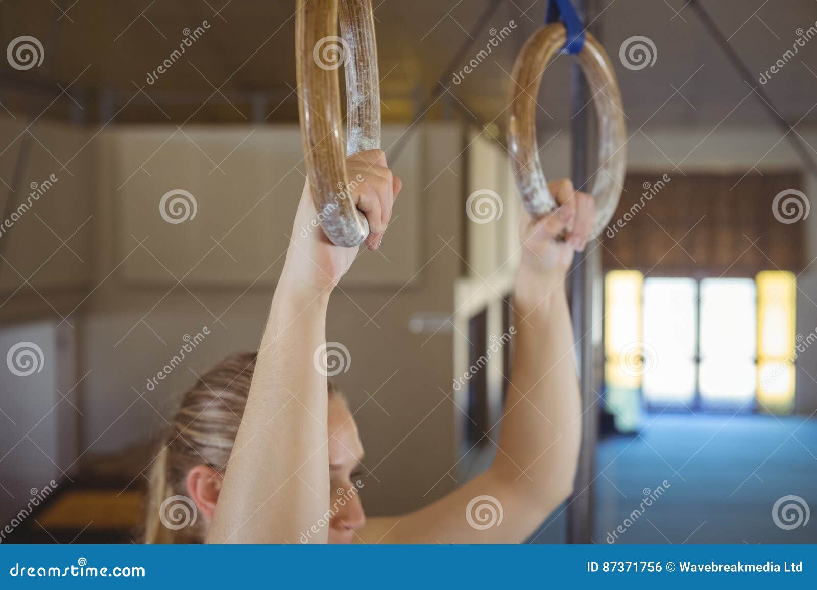 Female Gymnast Practicing Gymnastics on Rings Stock Photo - Image of ...