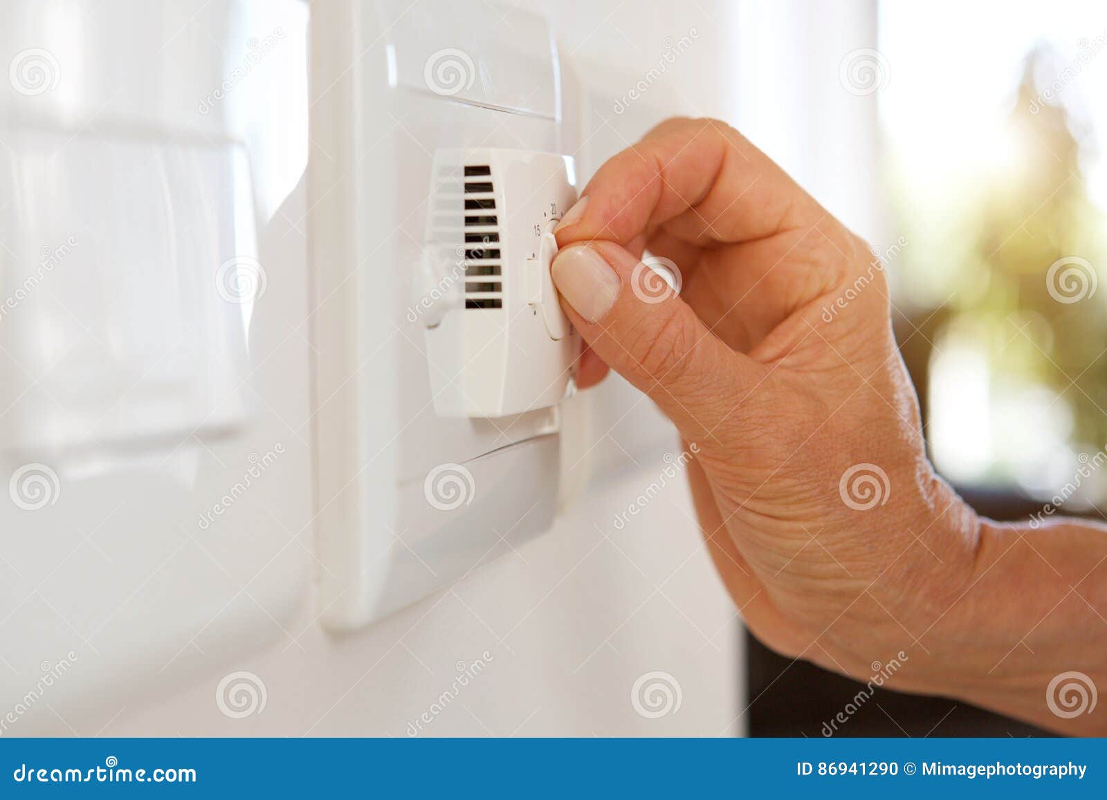 Female Hand Adjusting Temperature with Dial on Air Conditioning Stock ...